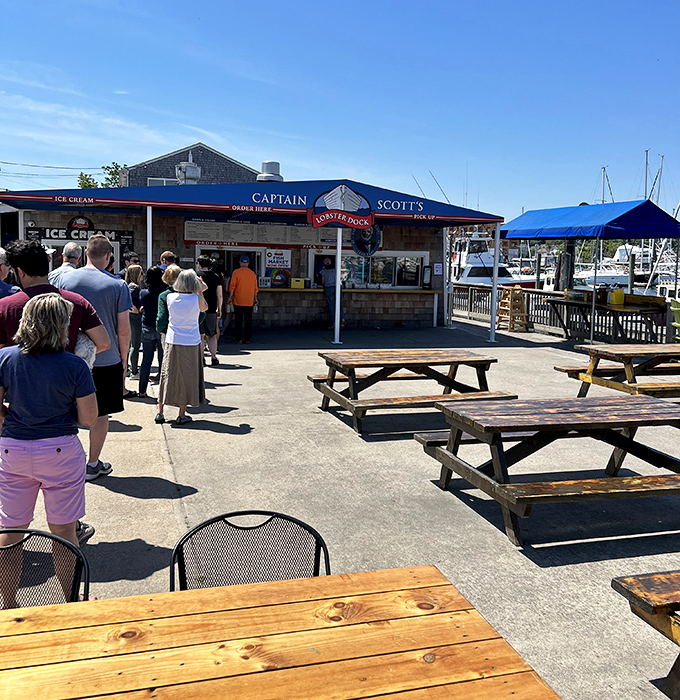 The colorful Adirondack chairs standing like sentinels of summer. These rainbow seats invite you to linger long after your meal.