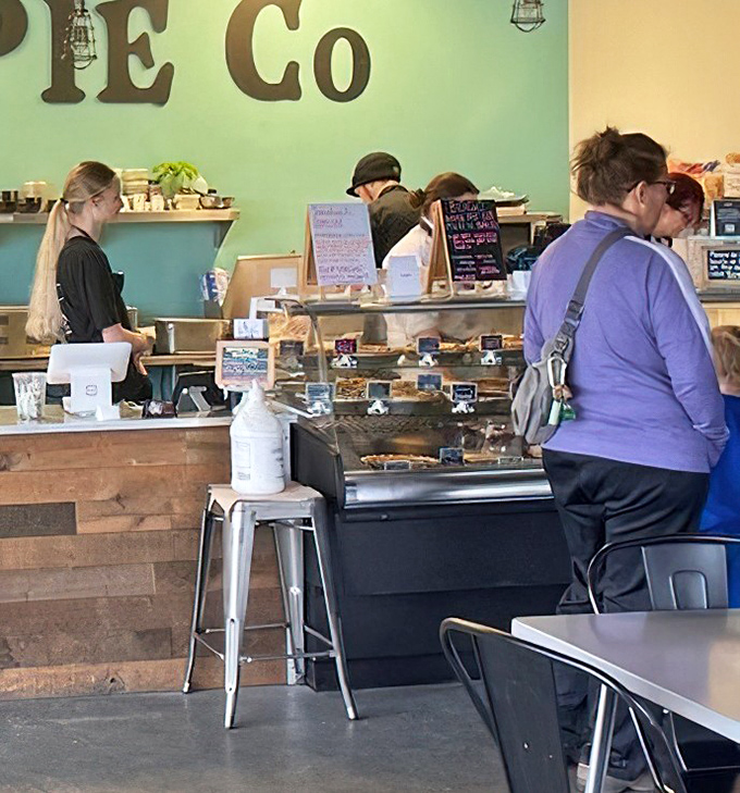 Where the magic happens – busy hands crafting deliciousness while customers eagerly await their turn at the counter.