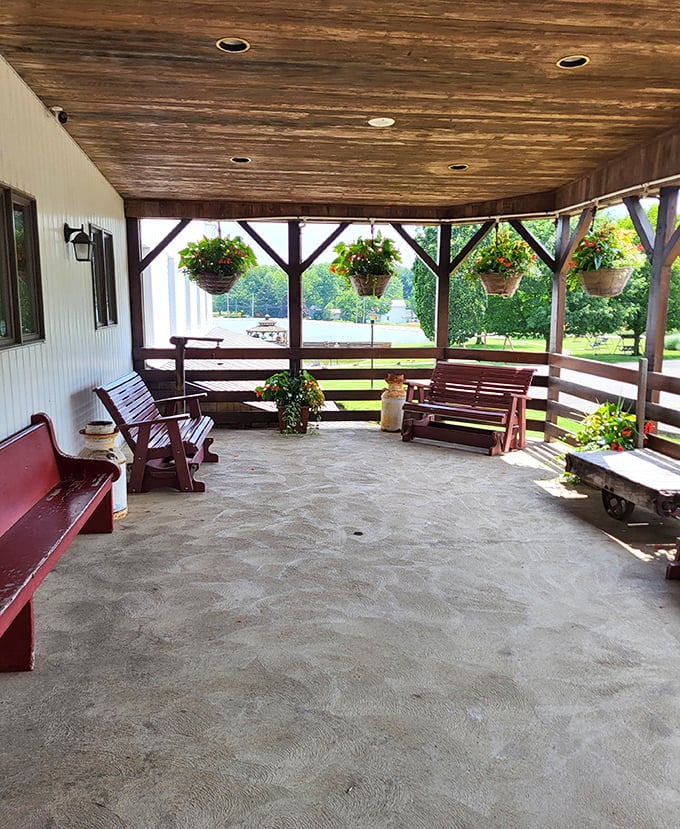 The covered porch with hanging baskets and wooden swings offers the perfect spot to digest while contemplating a second slice of pie.