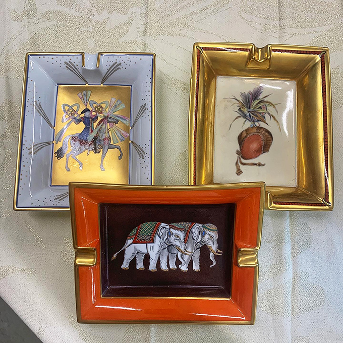 Decorative trays that once graced coffee tables in upscale homes now await their second act—that elephant design is particularly charming.