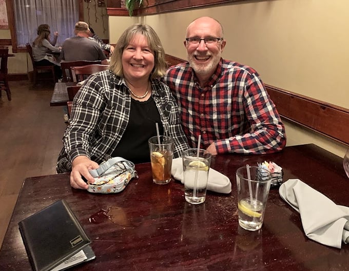 Happy diners sharing stories over glasses that never seem empty. The wooden interior creates the perfect backdrop for memories in the making.