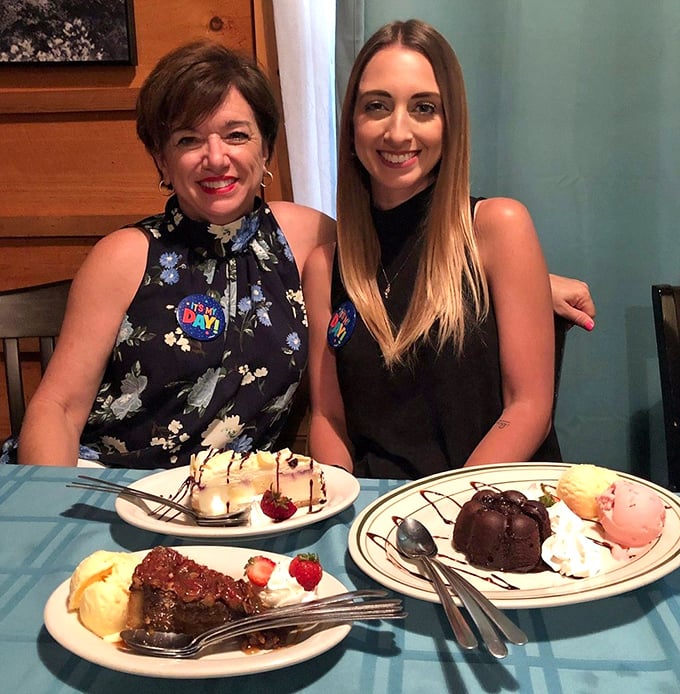 Happy diners enjoying what appears to be a celebration, complete with an impressive spread of desserts. Some memories are best made around a table.