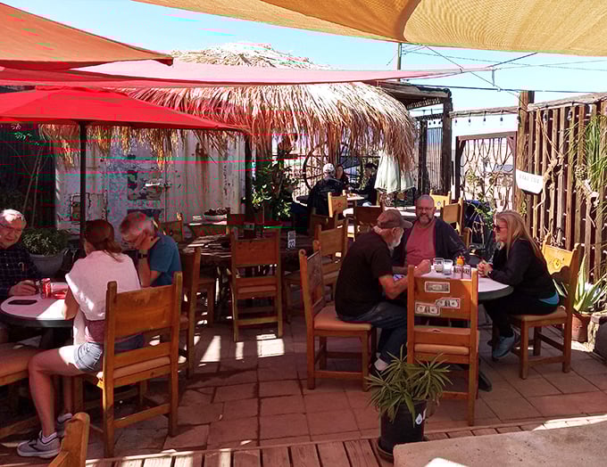 The outdoor patio&mdash;where strangers become friends over burgers and beers. Desert dining with a side of human connection under palm-thatched shade.