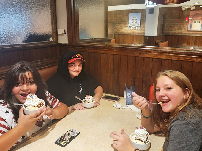 Happy diners enjoying ice cream treats &ndash; proof that Theo's desserts create moments of pure joy that demand to be shared.
