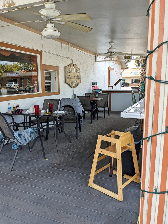 The outdoor dining area offers Florida sunshine with your coffee. Simple tables, ceiling fans, and zero pretension.