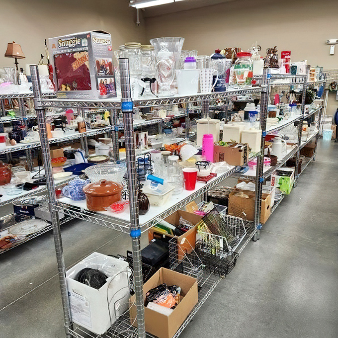 Kitchen essentials and curious gadgets line these shelves like an archaeological study of American dining habits. Pyrex collectors, prepare your shopping carts!