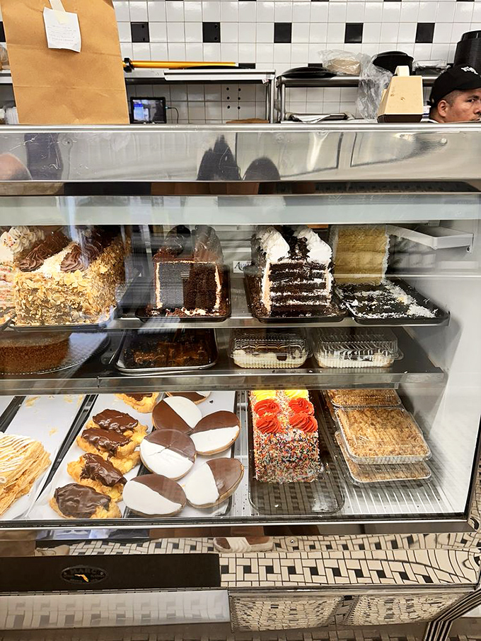 The dessert case stands as a monument to the philosophy that life is uncertain, so eat the black and white cookie first.