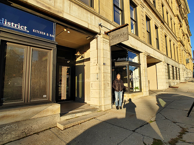 District Kitchen & Bar's inviting entrance promises culinary adventures within historic walls—comfort food with an elevated twist awaits.