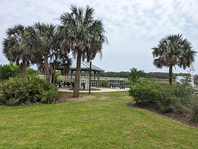 Palm trees frame this peaceful gazebo like nature's perfect picture frame&mdash;a spot where conversations linger longer than the afternoon sea breeze. 