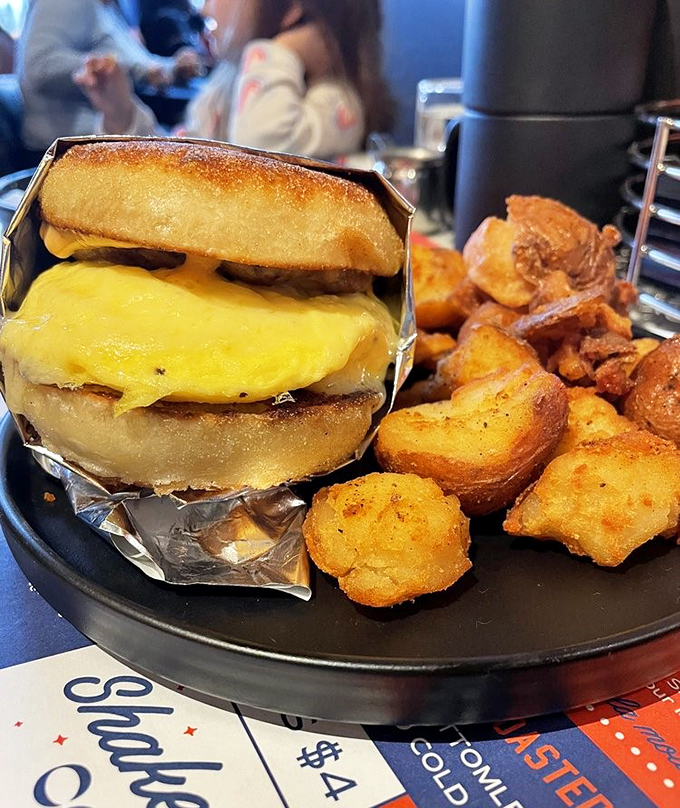 Breakfast engineering at its finest—a perfectly constructed egg sandwich wrapped in foil, ready to fuel your day with cheesy, protein-packed goodness.