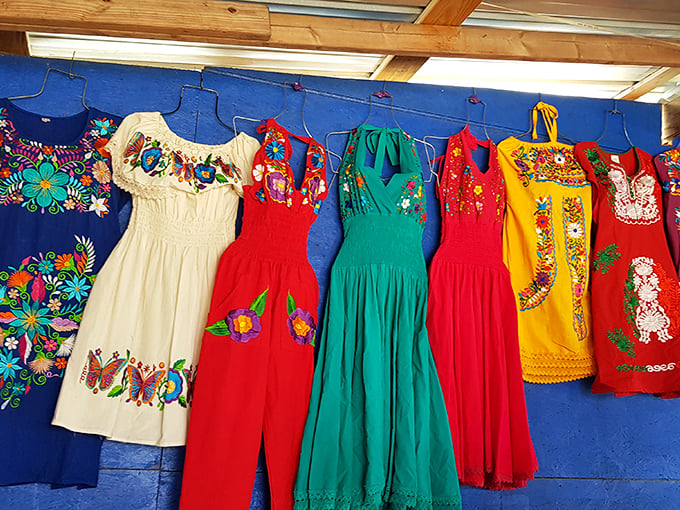 A rainbow of culture hanging on display. These vibrantly embroidered dresses showcase traditional craftsmanship that fast fashion could never duplicate.