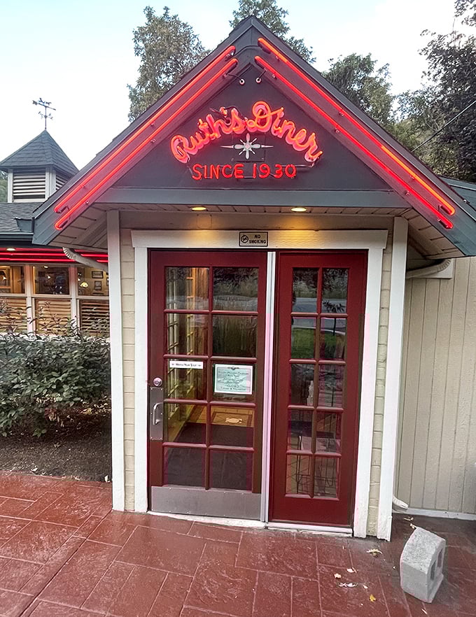 The neon-lit entrance glows like a beacon of breakfast hope, promising comfort food salvation to all who pass through these red doors.