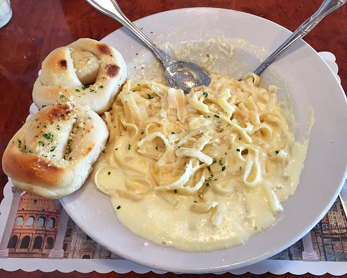 Fettuccine Alfredo so creamy it should come with a warning label. Those garlic knots are the supporting actors who steal the show.