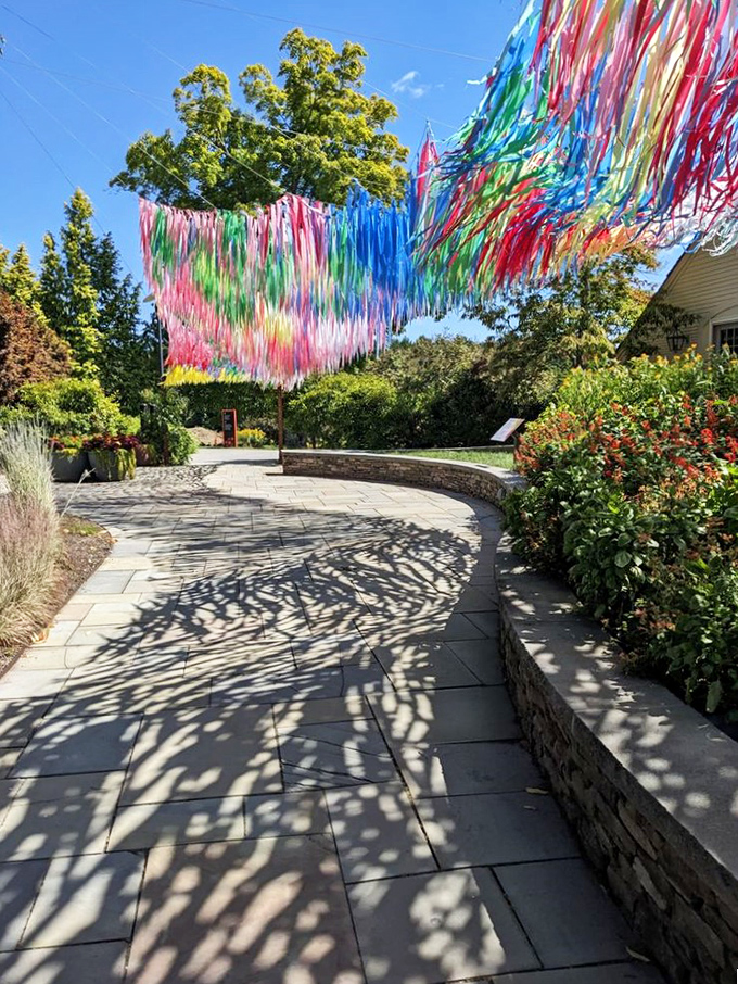 The colorful ribbon installation dances overhead like the world's most cheerful rain cloud. Precipitation we can actually get excited about!