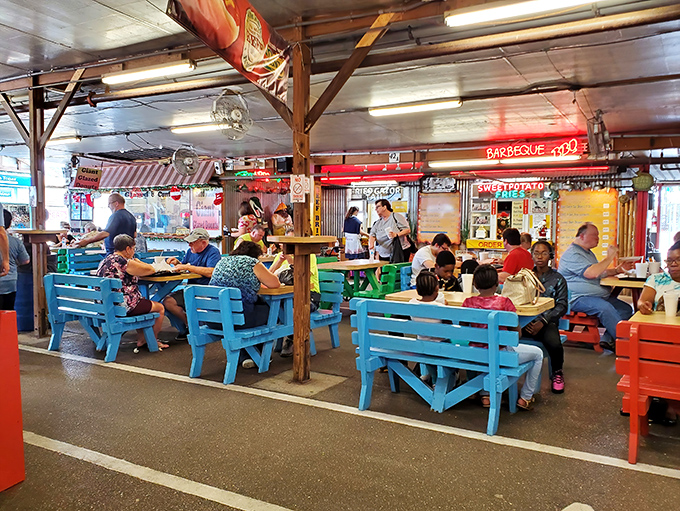 The food court's colorful benches invite shoppers to refuel and swap stories of their greatest finds of the day.