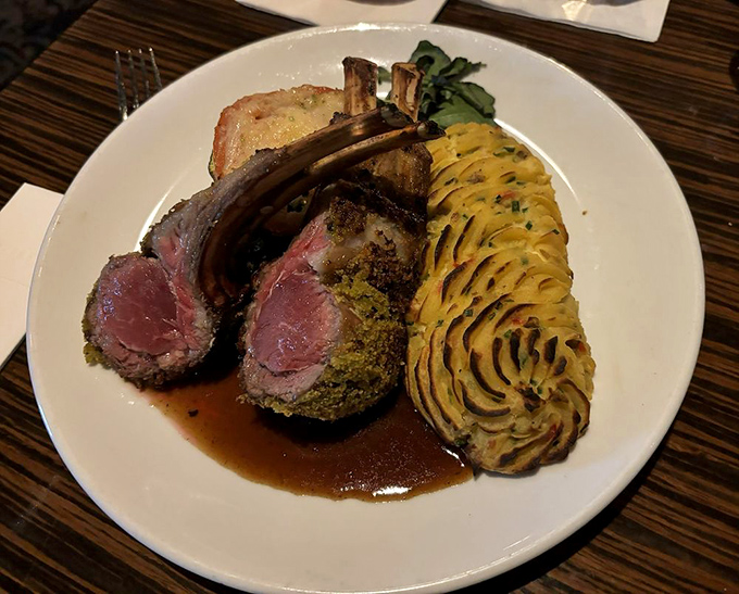 Lamb rack trimmed to perfection, served alongside stunning piped potatoes that command attention.