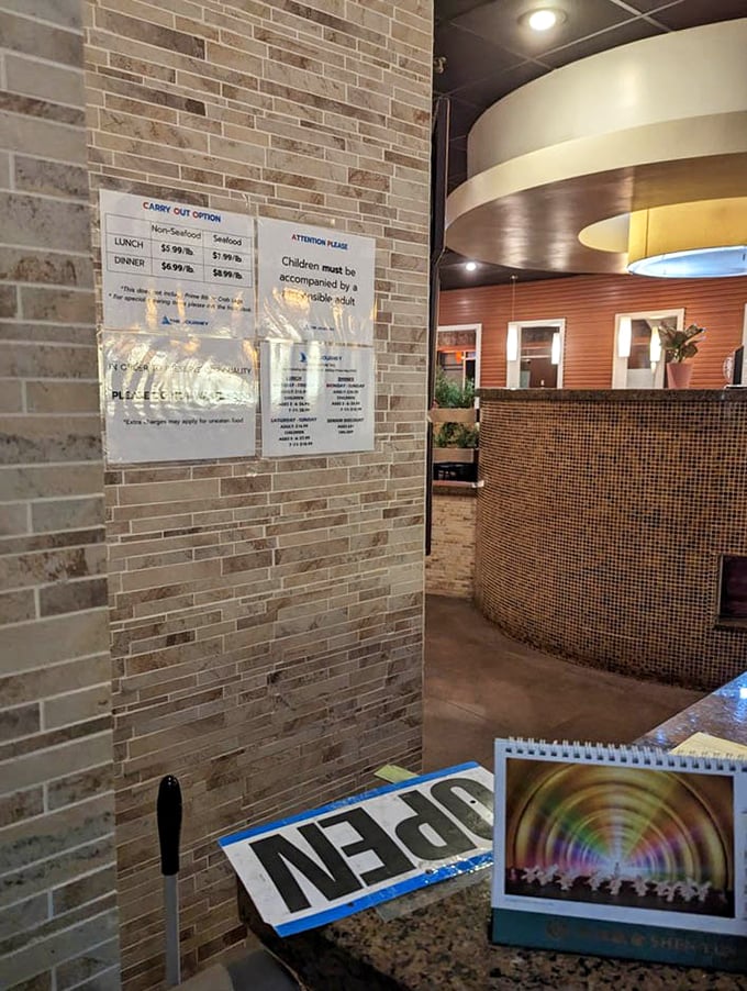 The entrance area welcomes guests with warm lighting and brick accents. First-timers beware: veterans know to turn right for prime rib, left for seafood.