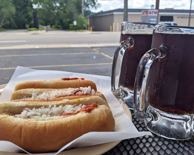 The perfect pairing: frosted mugs of that famous house-made root beer alongside hot dogs topped with their signature chili sauce and onions.