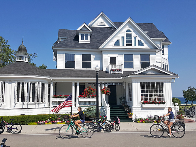 The stately Hotel Iroquois welcomes cyclists with its classic white fa&ccedil;ade, wraparound porch, and flower boxes bursting with summer color.