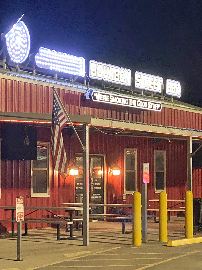 Bourbon Street BBQ's rustic charm and neon glow beckon meat lovers like a carnivorous lighthouse. The American flag says "patriotic eating" is encouraged.