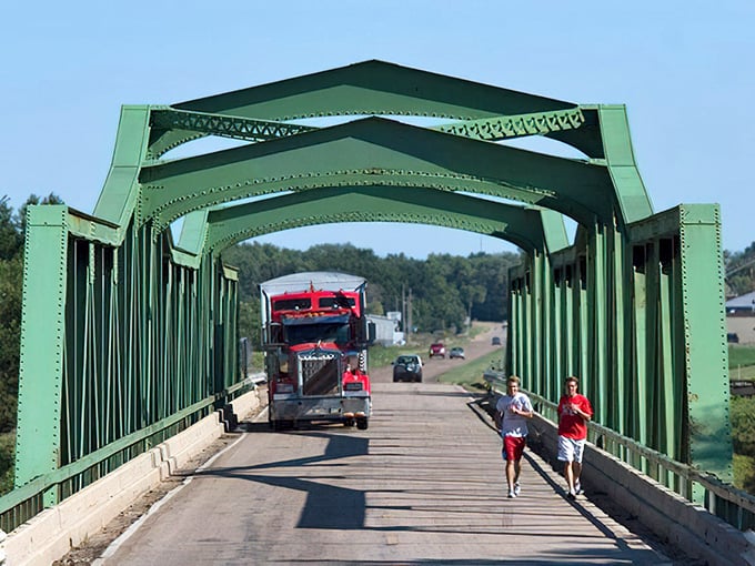 The green bridge spans more than just water—it connects Red Cloud's past to its present, offering passage to adventures on both sides.