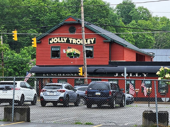 The Jolly Trolley restaurant's vibrant red exterior promises comfort food that hugs your insides like your grandmother's embrace.