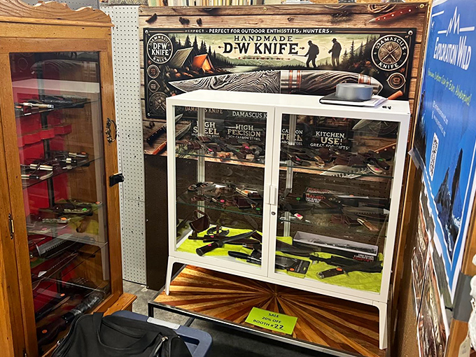 A knife collection that'd make any outdoorsman weep with joy, displayed safely behind glass for everyone's protection and admiration.