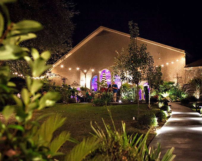 La Belle Venue transforms into a magical garden at night, where string lights and lush plants create the perfect Louisiana evening.