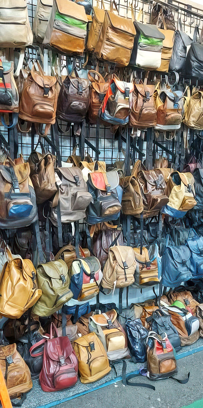 Leather backpack heaven! These vintage-style bags hang like ripening fruit, each one promising adventures and compliments in equal measure.