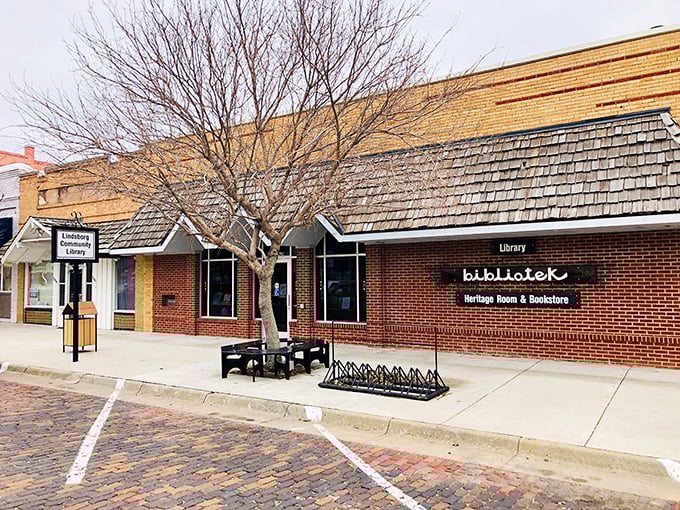 The "bibliotek" sign says library, but this brick building whispers "come inside and travel without leaving your chair."