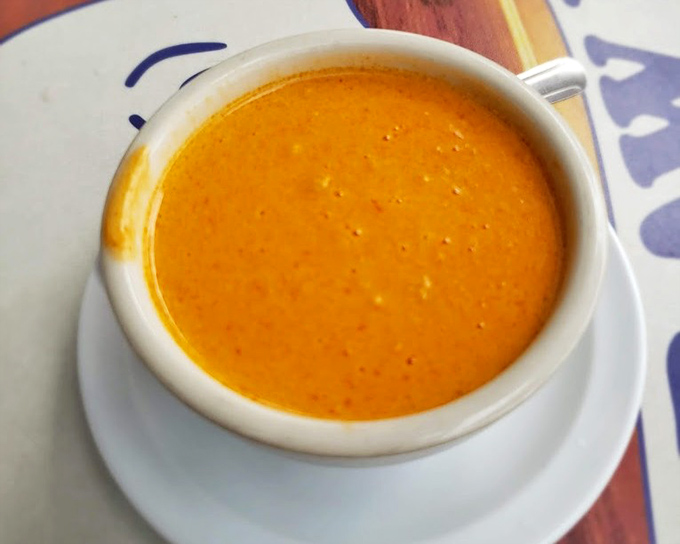 This lobster bisque isn't just soup; it's a warm, coral-colored hug in a bowl that whispers, "Everything's going to be alright."