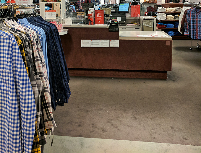 Plaid shirts stand at attention like fabric soldiers, each one promising to make its future owner look outdoorsy, regardless of actual wilderness skills.