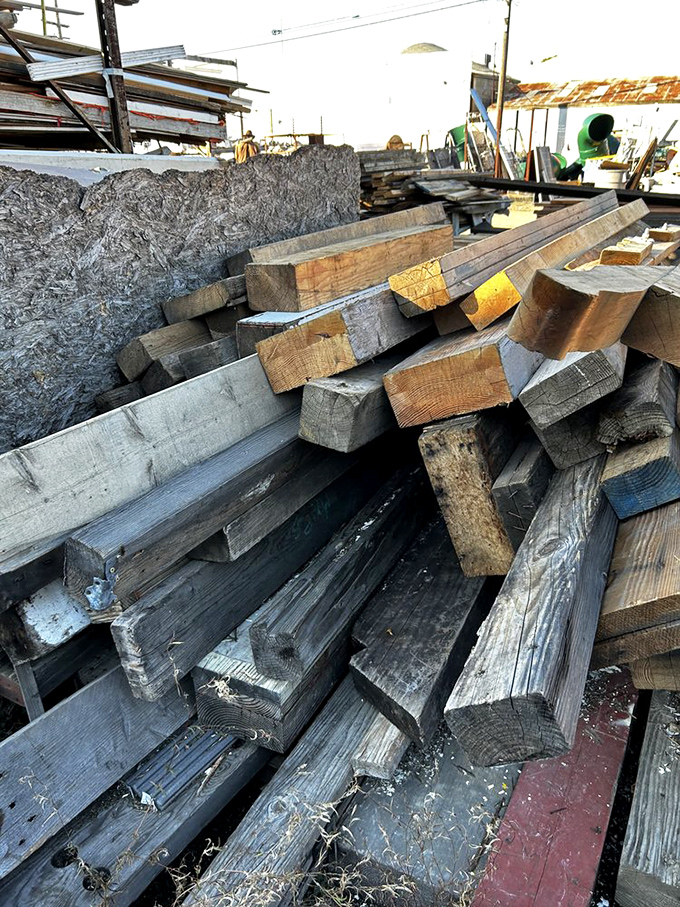 Reclaimed lumber stacked like pickup sticks for grown-ups. Each board carries the patina of its previous life.