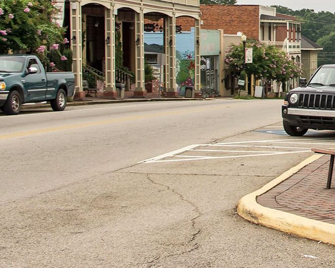 Main Street curves gently, revealing itself one storefront at a time. The cracked pavement tells you this place values history over perfection.