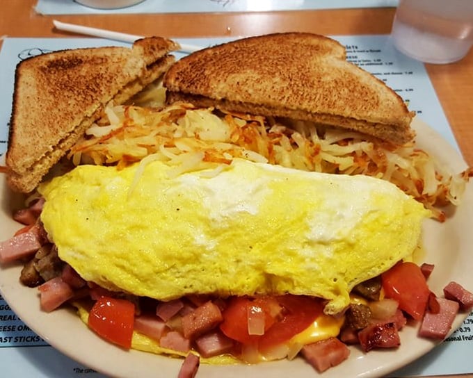 This isn't just an omelet&mdash;it's a treasure hunt. Every forkful reveals new delights hiding among fluffy eggs, with golden hash browns standing guard.