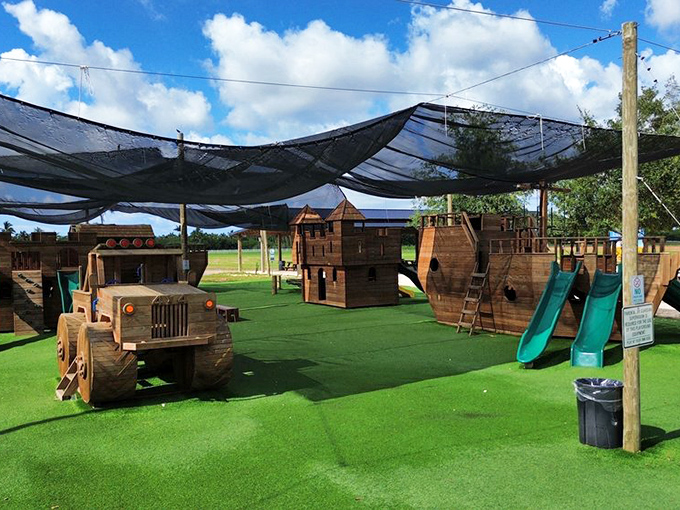 This wooden playground fort and truck would make Tom Sawyer jealous&mdash;modern kids getting old-fashioned fun between berry-picking sessions.