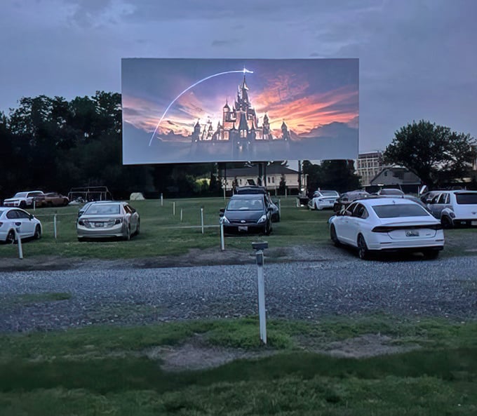 As the Disney castle illuminates the night sky, car windows become personal viewing portals to cinematic magic.