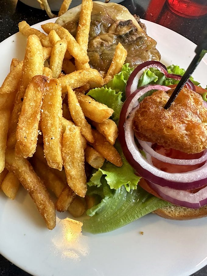 A burger that requires both hands and a strategy. Those crispy fries are the supporting actors deserving their own award.