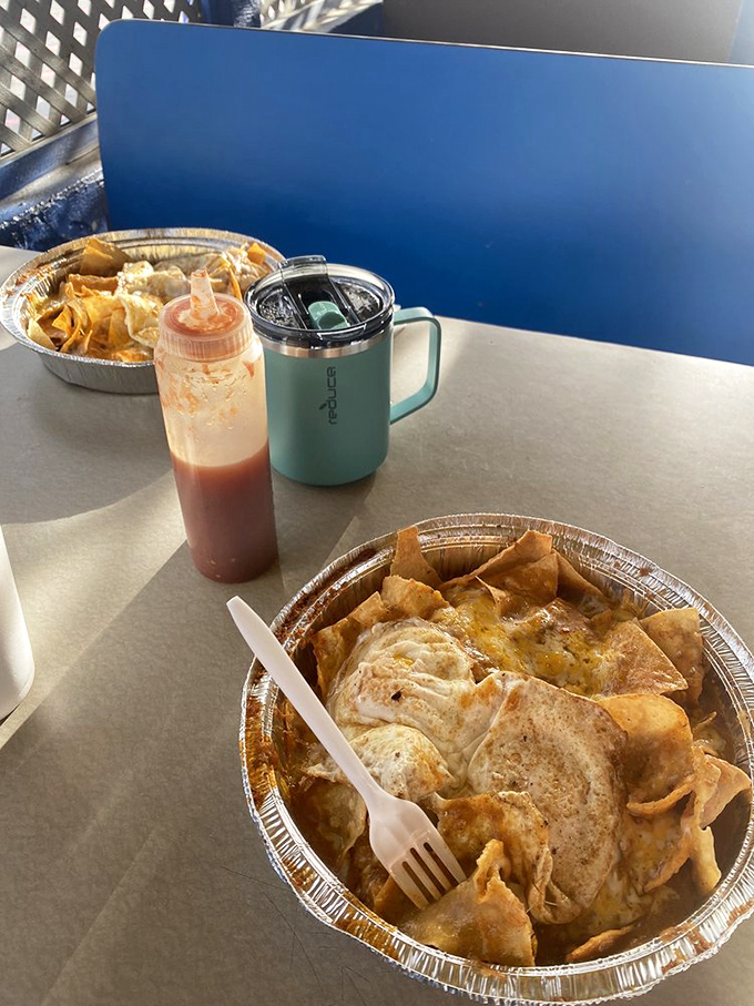 Nachos that laugh in the face of restraint. That red sauce bottle isn't a condiment&mdash;it's an invitation to take things to the next level.