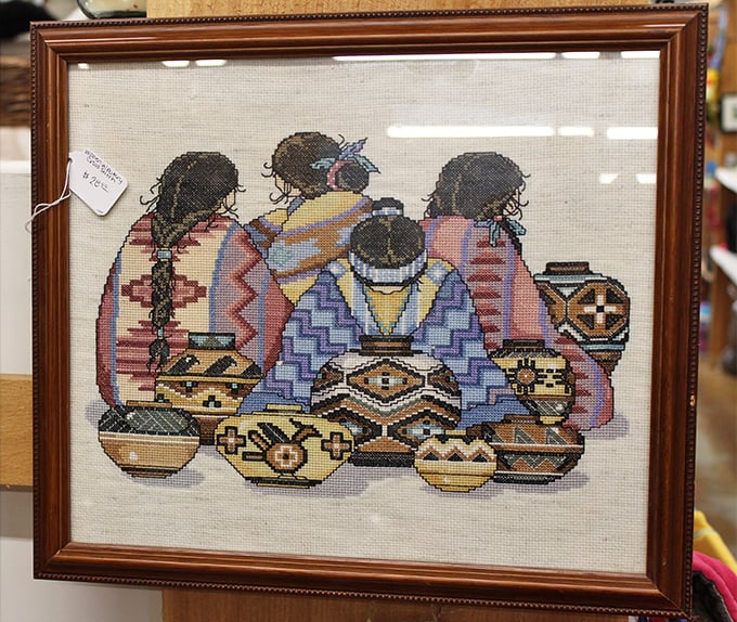 Needlework that tells stories across cultures. This framed cross-stitch captures the artistry and tradition of Native American pottery makers.