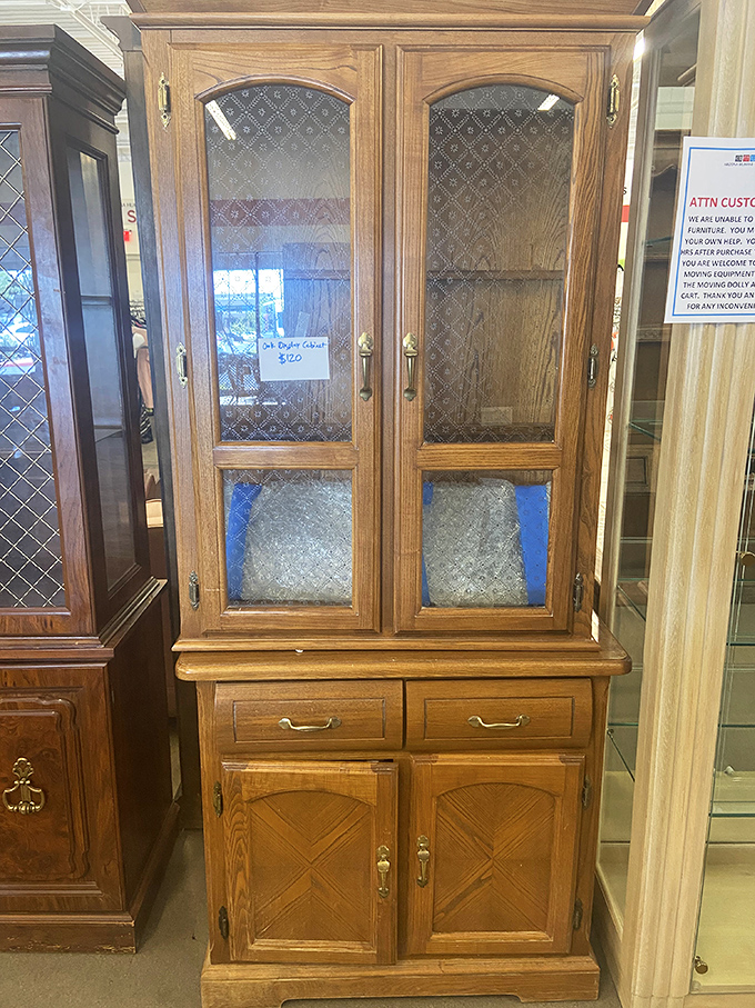 Not just a cabinet but a time capsule of craftsmanship, with glass panels that showcase whatever treasures you deem worthy of display.