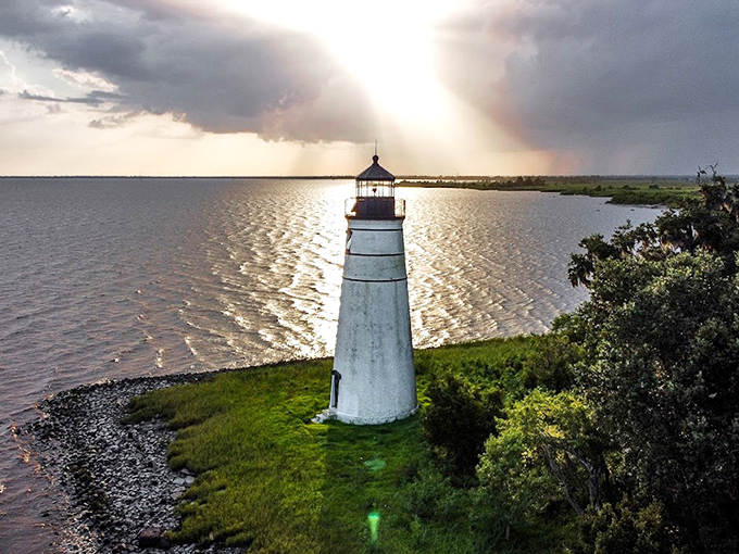 Weathered yet elegant, the lighthouse wears its age with grace, each mark and stain telling stories of hurricanes survived and seasons endured.