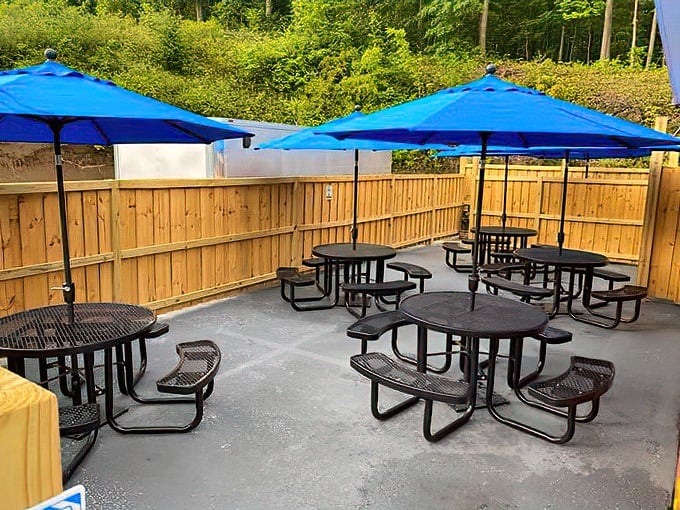 The outdoor patio offers a breath of fresh mountain air between bites, with blue umbrellas providing shade for those sunny Pennsylvania afternoons.