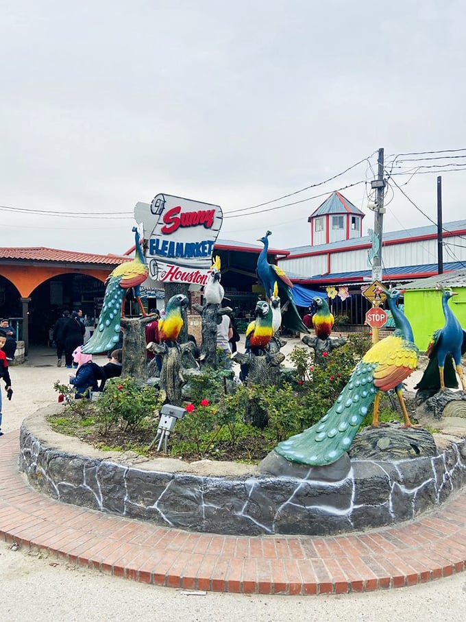 The market's entrance announces itself with peacock guardians and tropical flair. Like the Vegas Strip for bargain hunters, this sign promises adventure beyond the ordinary. 
