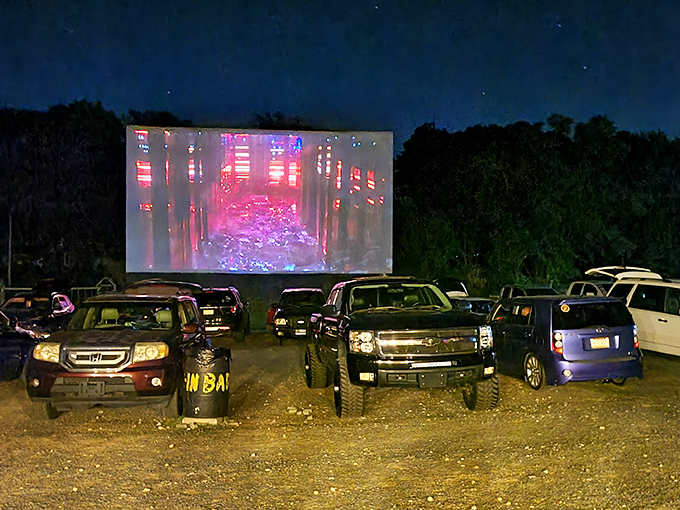 Night falls, headlights dim, and the screen comes alive with color&mdash;transforming a simple field into a communal cathedral of storytelling.