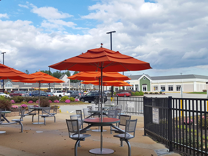 Orange umbrellas and outdoor seating offer respite for weary bargain hunters needing to recharge between retail rounds.