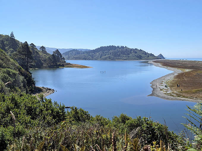 The lagoon's gentle curve creates a perfect postcard moment. Those tiny figures in the distance give scale to this vast natural amphitheater.