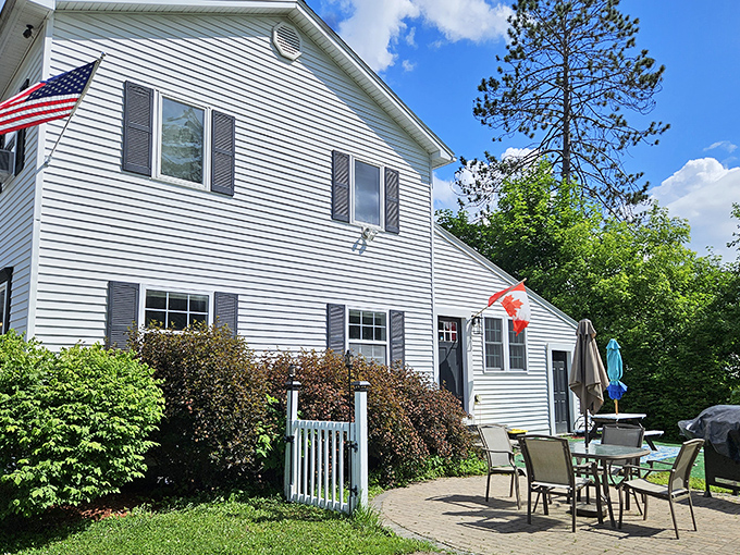 This classic New England home with its welcoming patio whispers the promise of peaceful retirement mornings with coffee and birdsong.