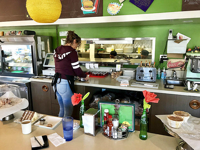 Behind the scenes magic where breakfast dreams come true. Those flowers in green bottles add a touch of homeyness to the professional setup.
