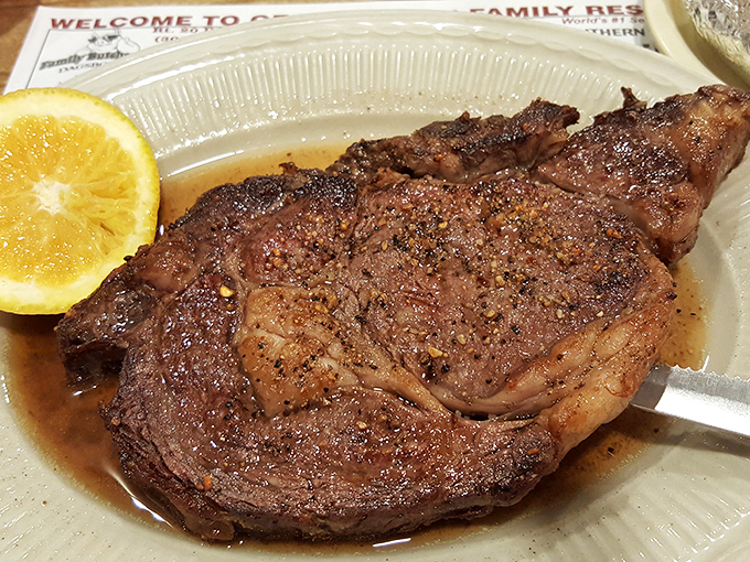 A steak so perfectly cooked it deserves its own slow-motion entrance music, complete with a citrus sidekick for that perfect finishing touch.